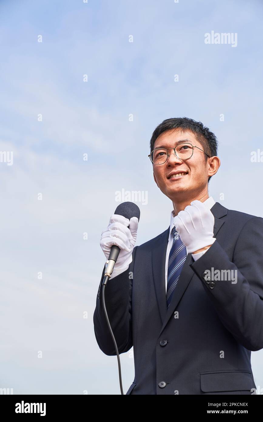 Man in suit with microphone Stock Photo - Alamy