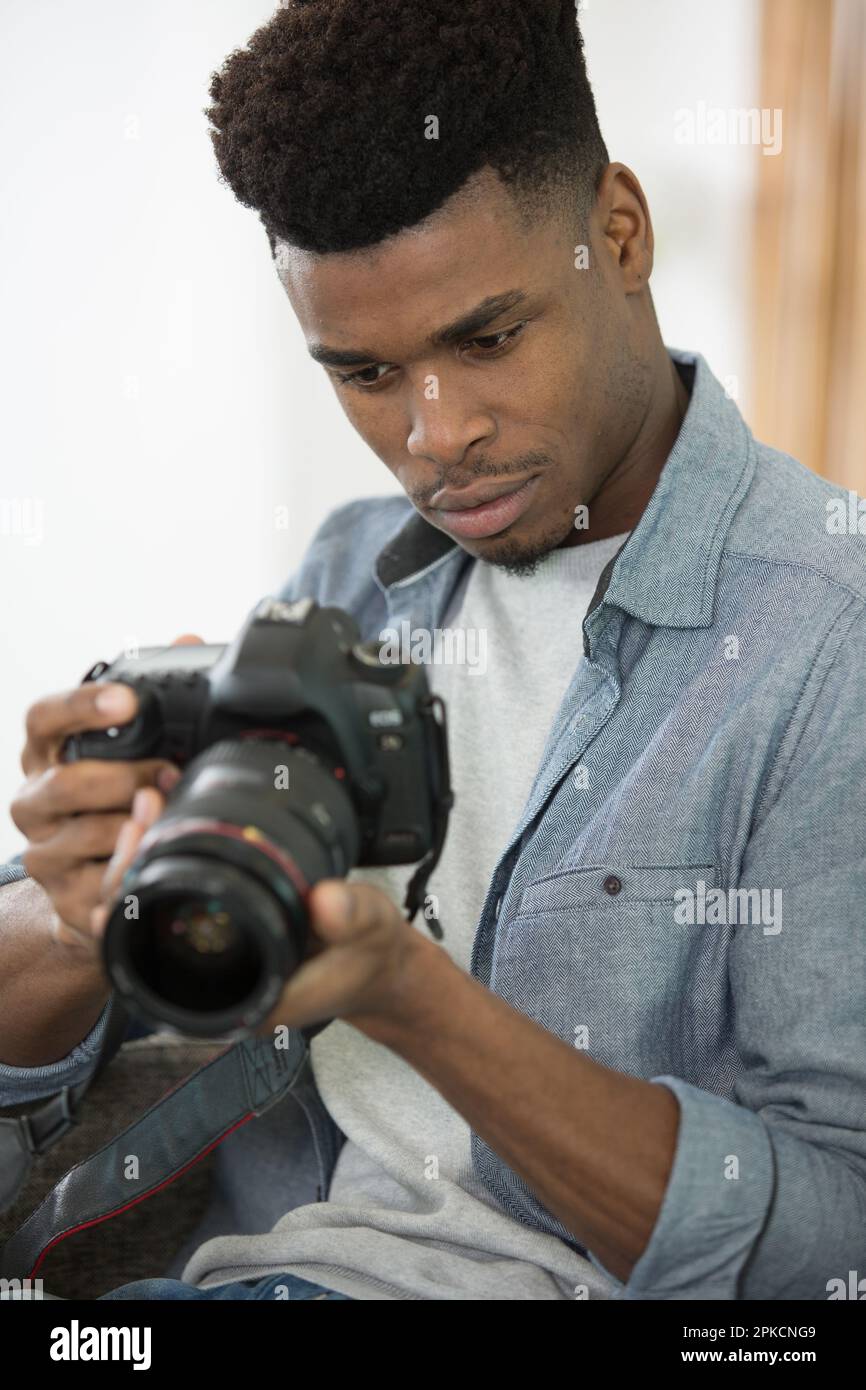 young man fixing a camera Stock Photo - Alamy