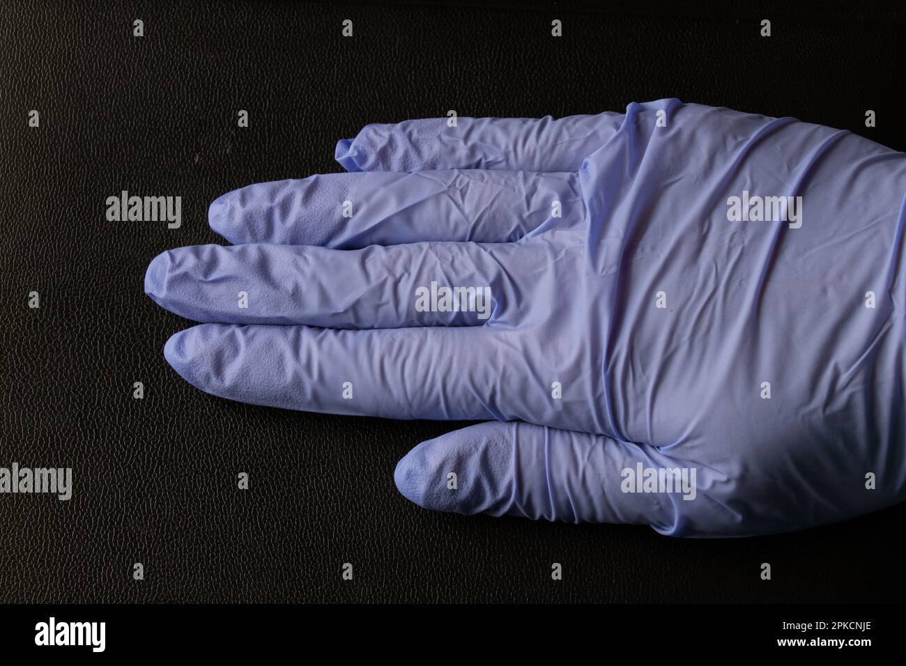 Hand in blue nitrile gloves hi-res stock photography and images - Alamy