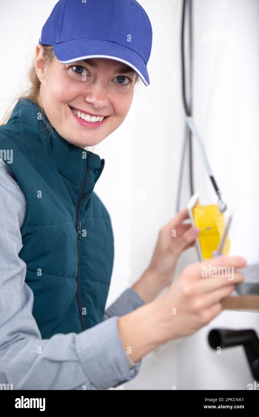 female electrician fixing socket electricity problem Stock Photo - Alamy