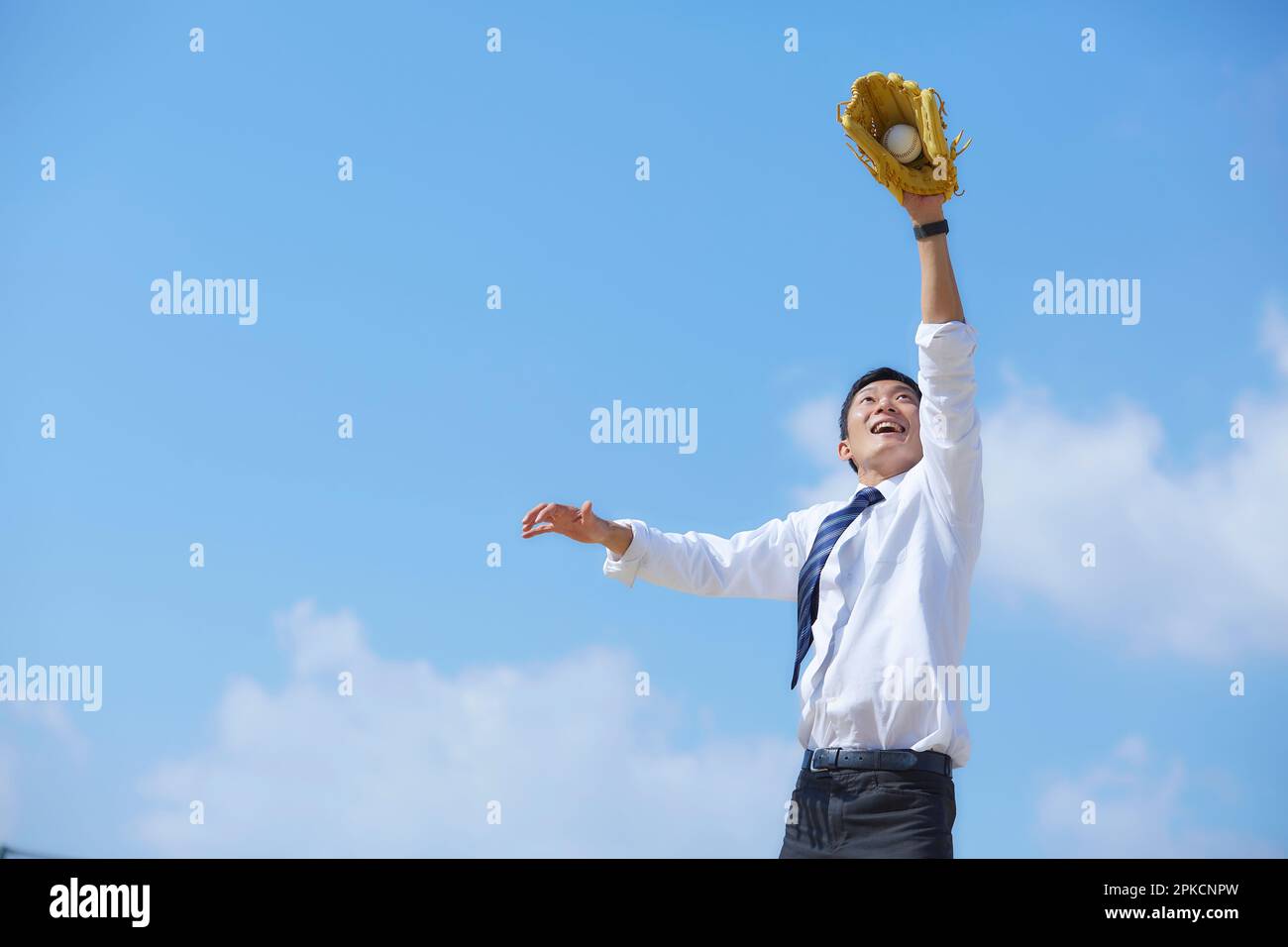 Man in suit reaching out his hand with glove under blue sky Stock Photo ...