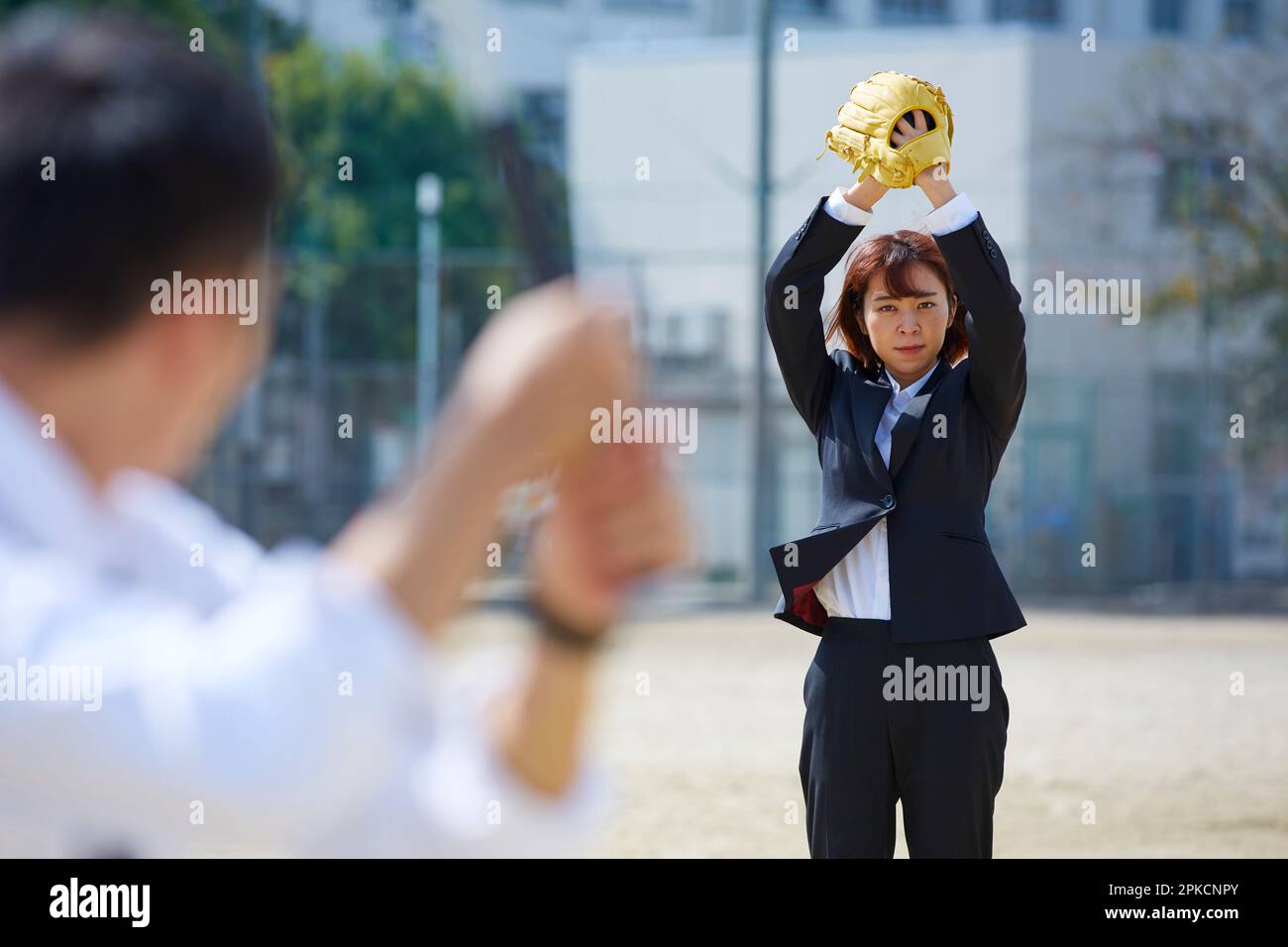 Woman in suit winding up Stock Photo - Alamy