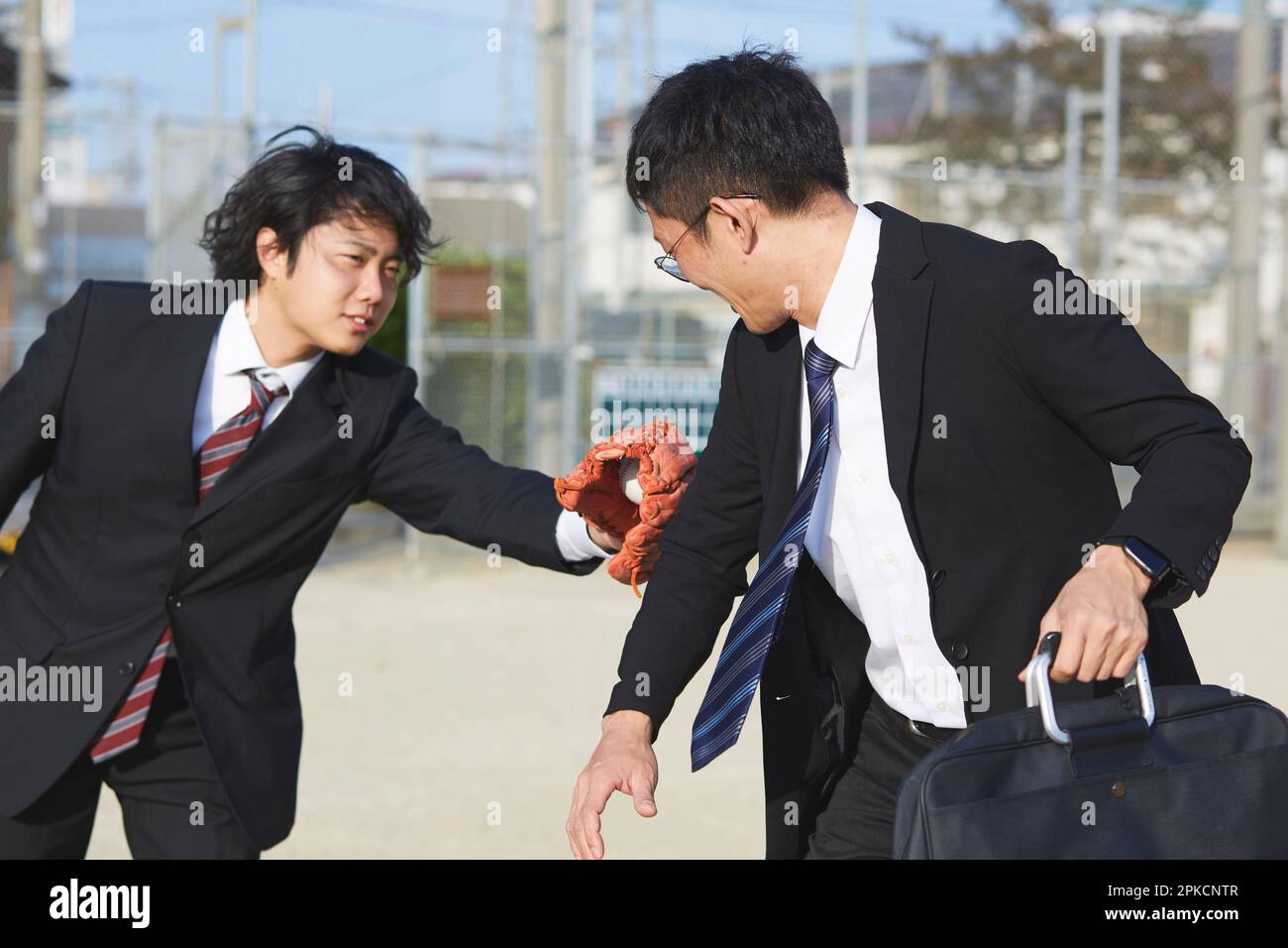 Two men in suits touching out Stock Photo - Alamy
