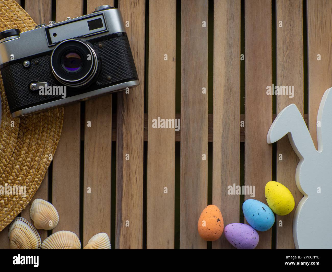 Easter background with straw hat, photo camera, colorful eggs and white ...