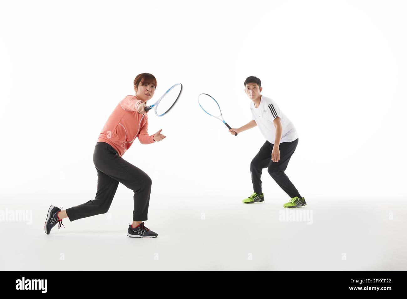 Men and women holding rackets in tennis doubles Stock Photo - Alamy