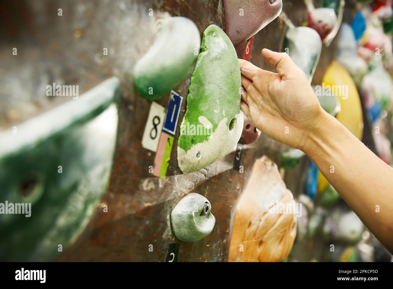 Man's hand hooking finger on hold while bouldering Stock Photo - Alamy