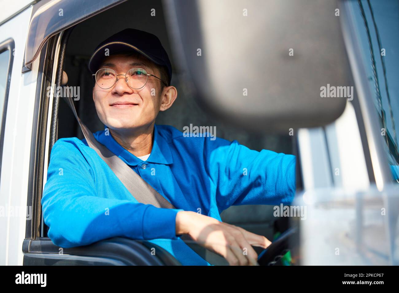 Man in work clothes driving a truck Stock Photo - Alamy