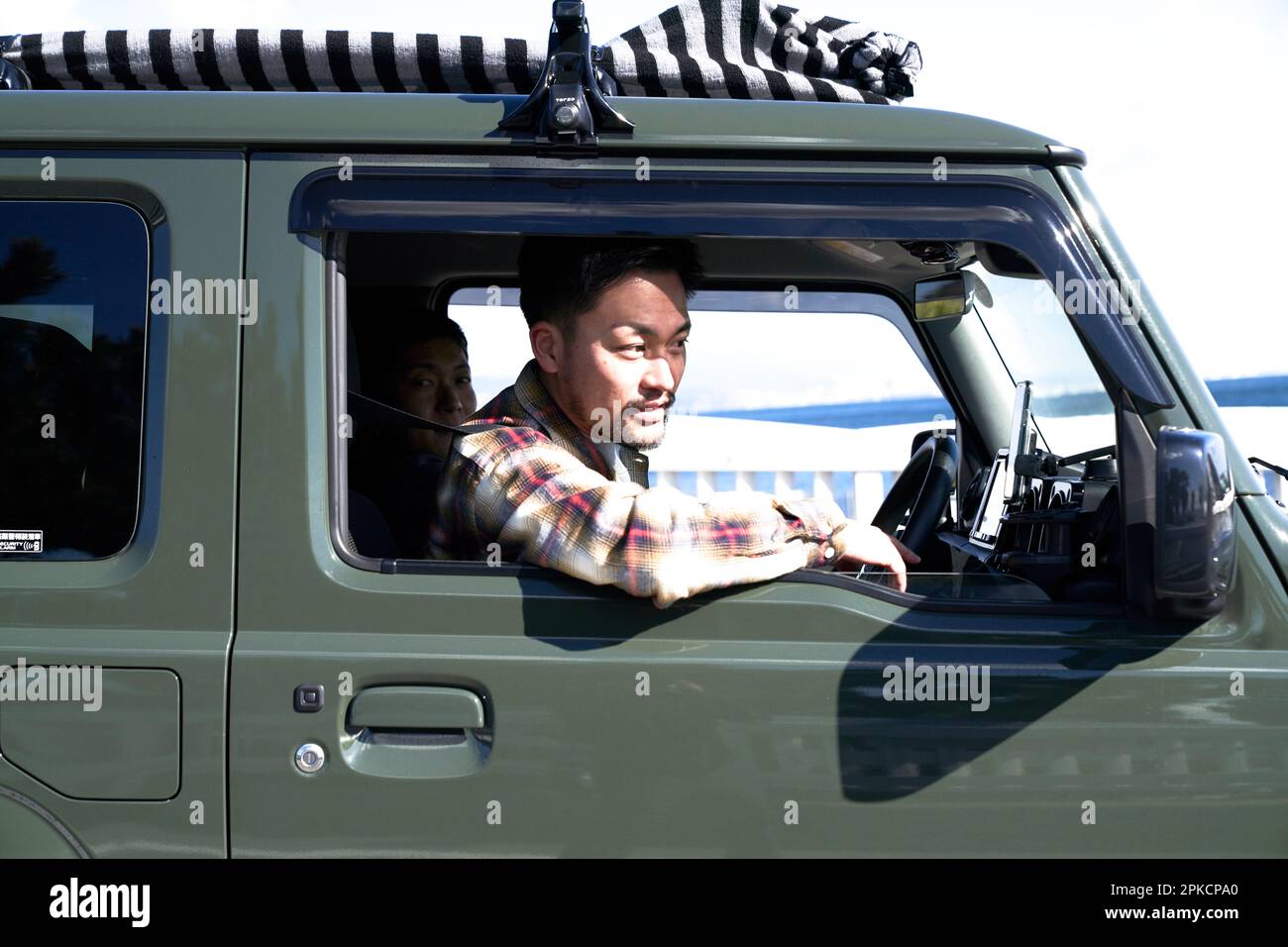 Man looking forward through car window Stock Photo - Alamy