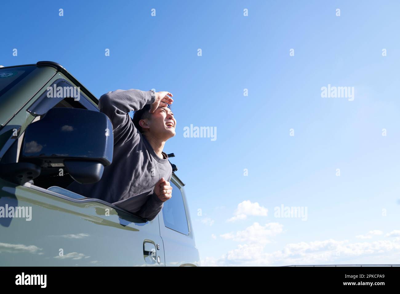 Man leaning out of passenger window of car Stock Photo - Alamy