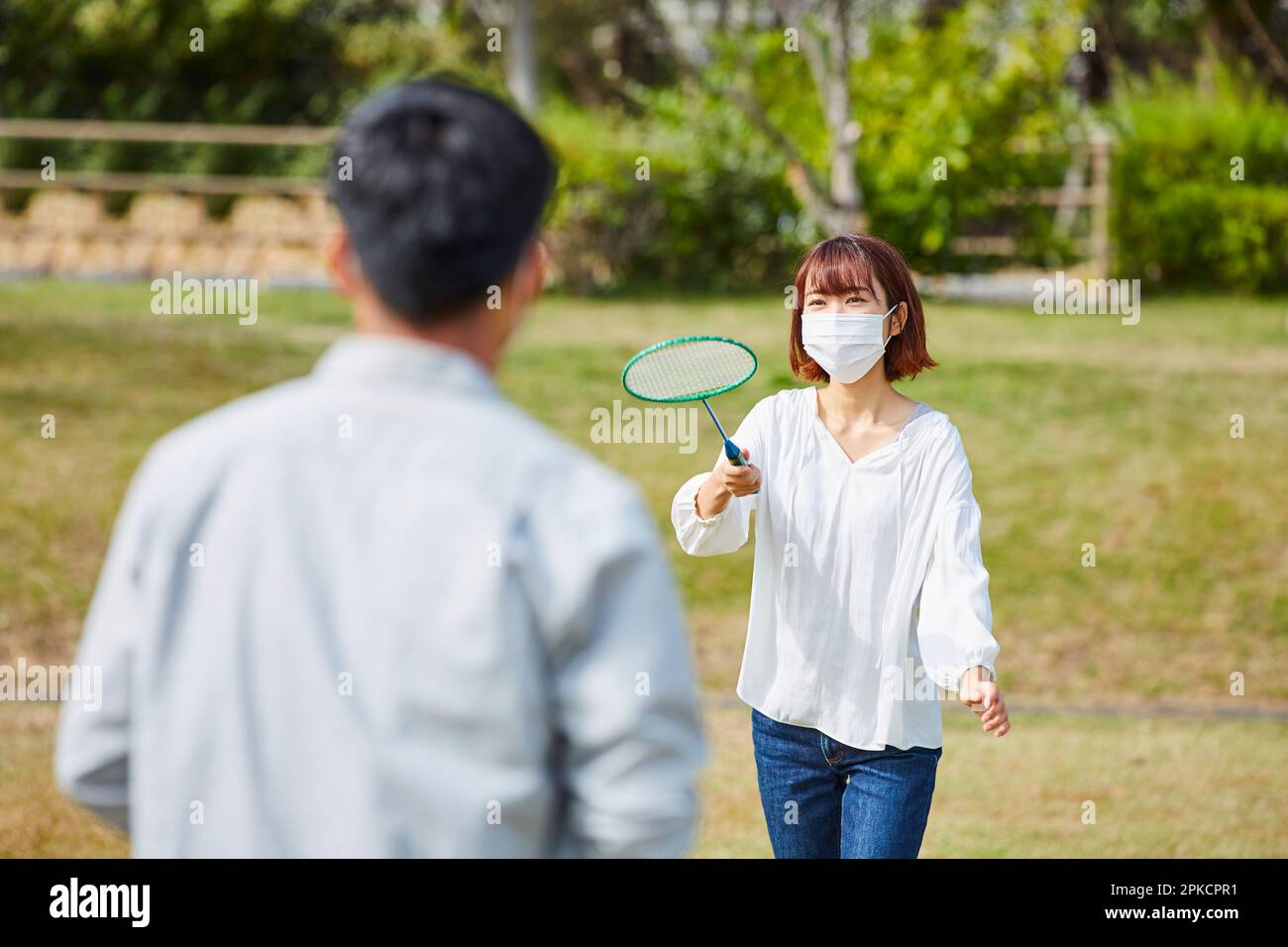 Men and women playing badminton wearing masks Stock Photo - Alamy