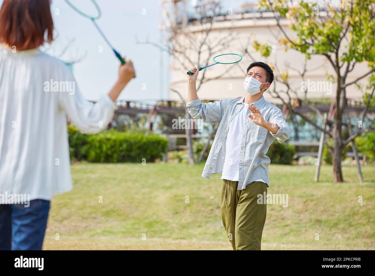 Men and women playing badminton wearing masks Stock Photo - Alamy