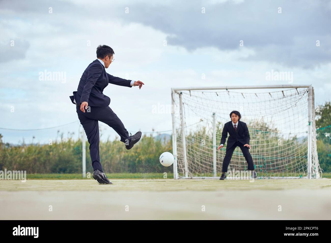 A businessman shooting a ball Stock Photo - Alamy