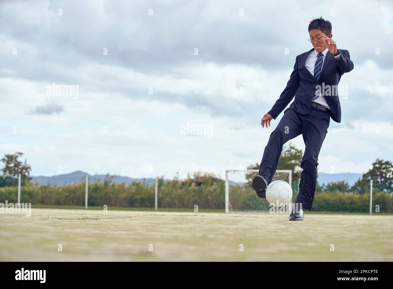 A businessman shooting a ball Stock Photo - Alamy