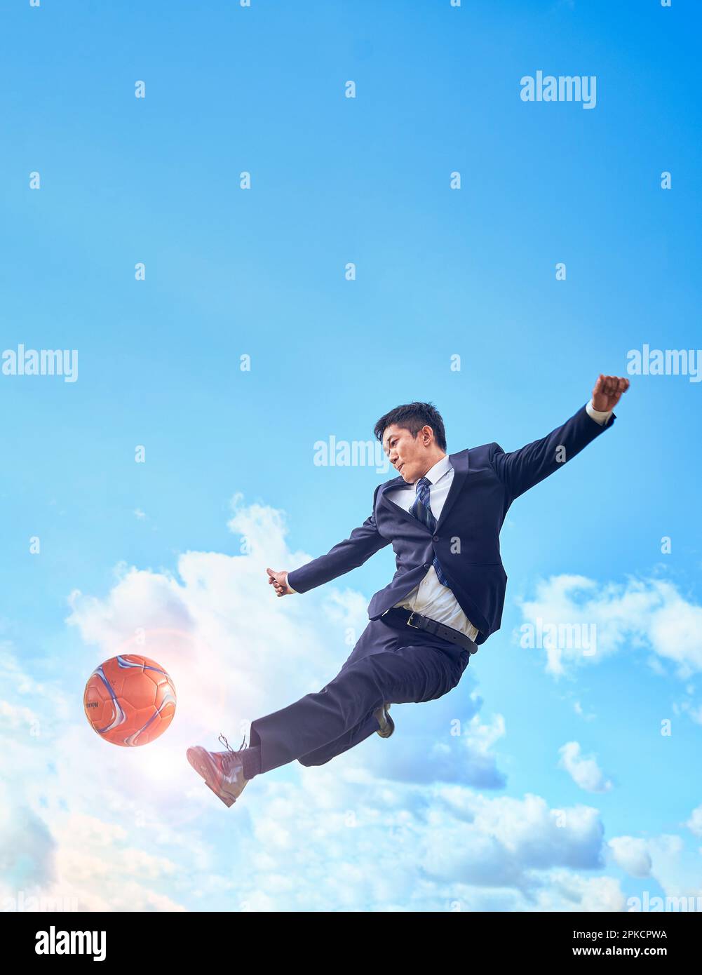 A businessman doing a volley kick Stock Photo - Alamy