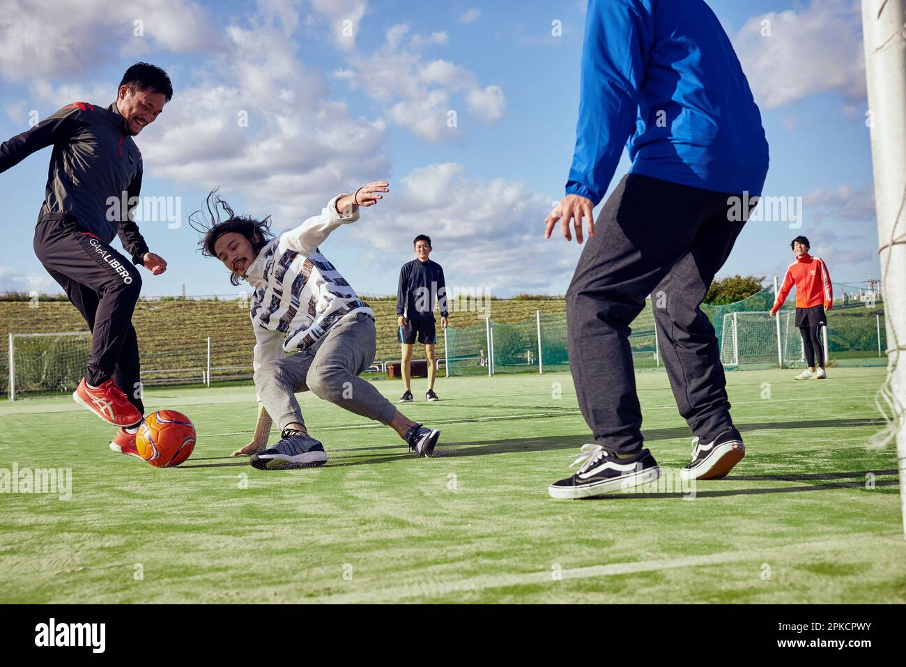 A sportsman trying to get the ball by sliding Stock Photo - Alamy
