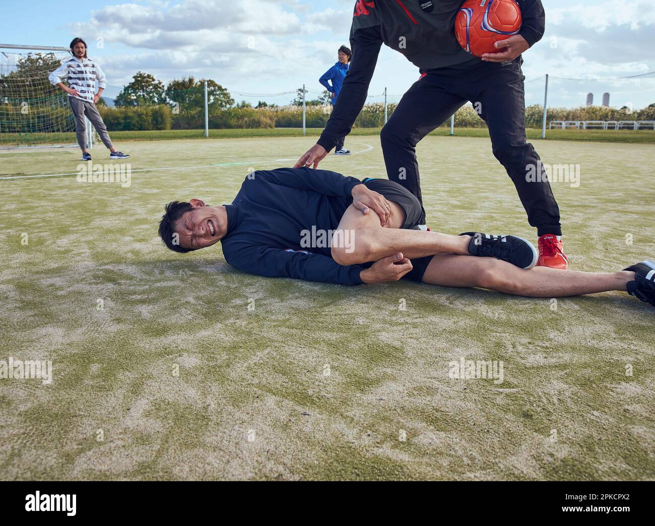 A sportsman falling down with an injury Stock Photo - Alamy