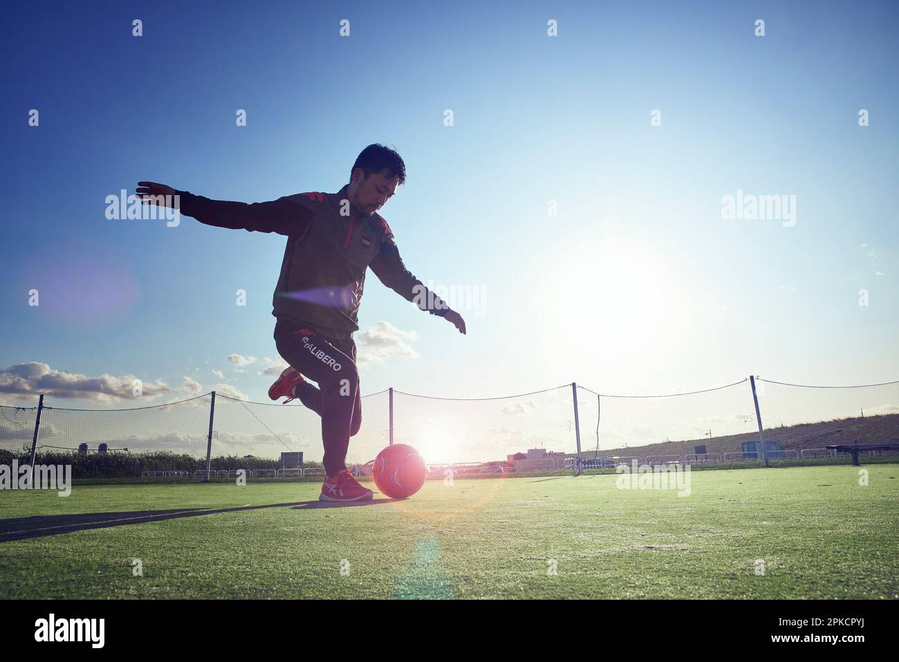 Asian soccer player kicking ball hi-res stock photography and images ...