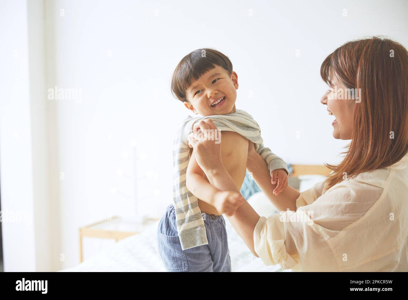 Boy getting dressed with a smile Stock Photo - Alamy