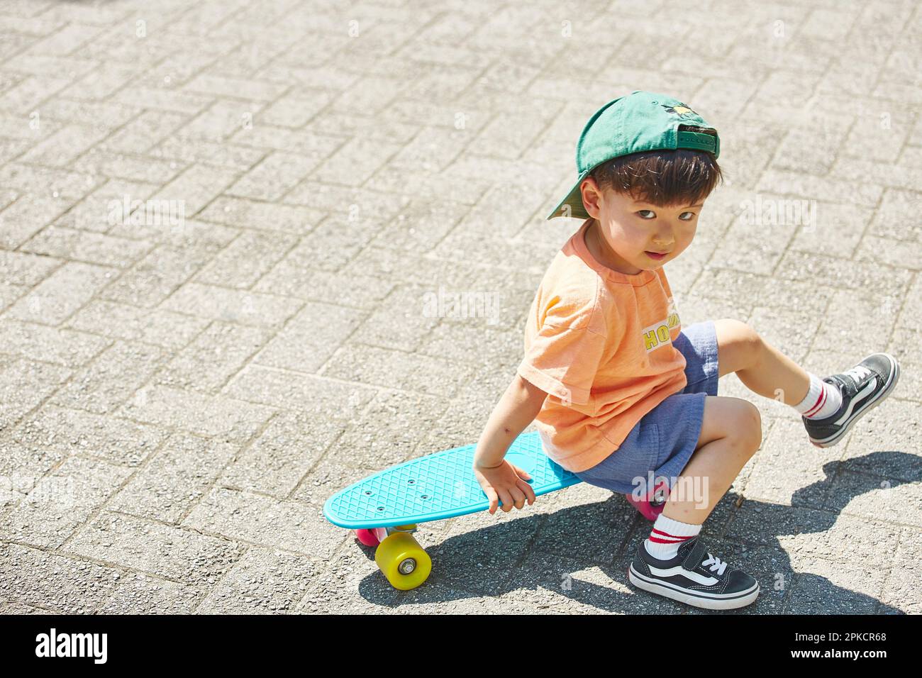Boy playing on skateboard Stock Photo - Alamy