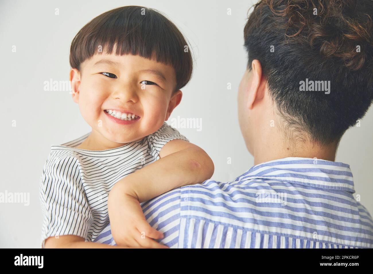 Smiling boy being held by his father Stock Photo - Alamy