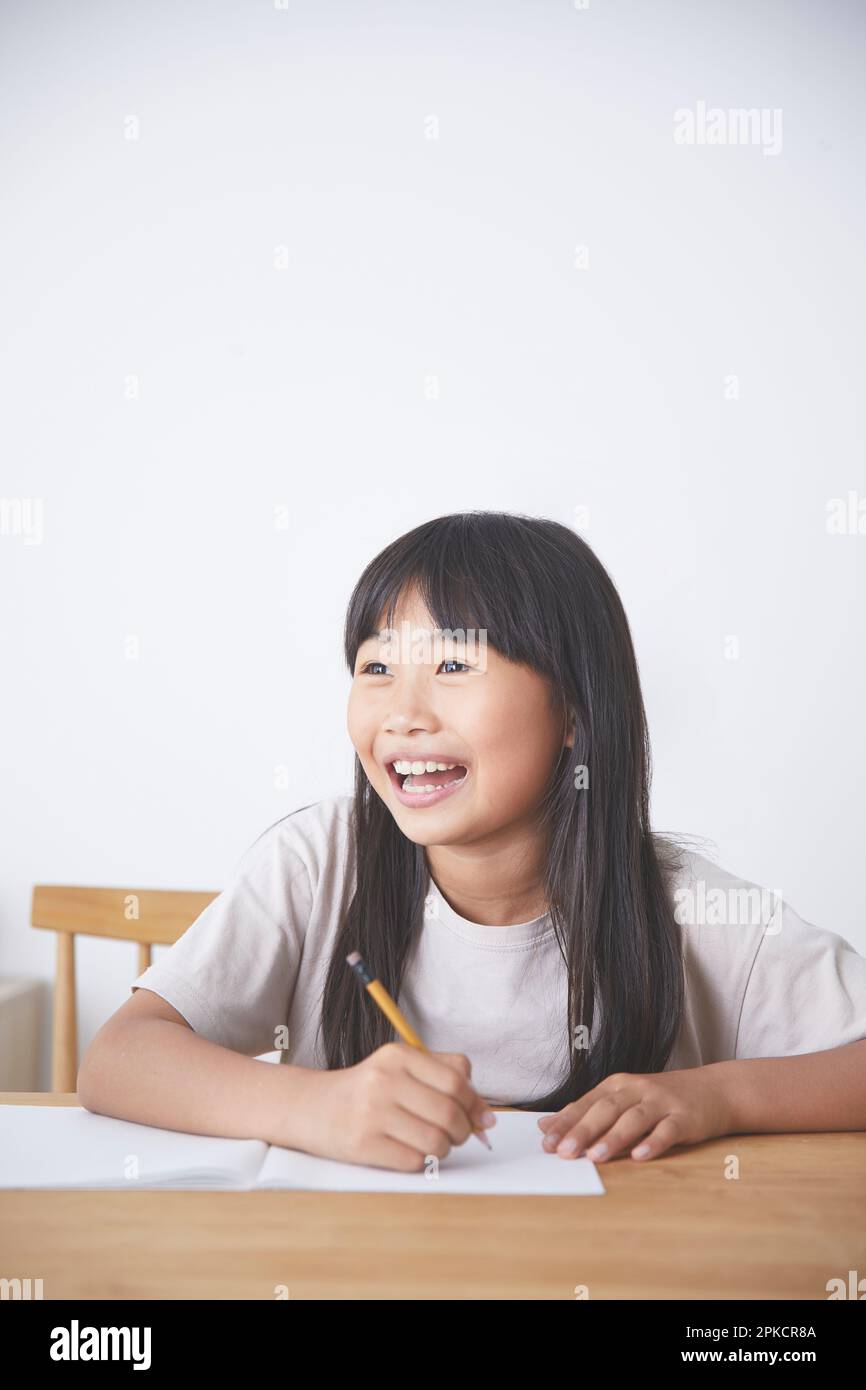 Smiling Girl Studying Stock Photo - Alamy