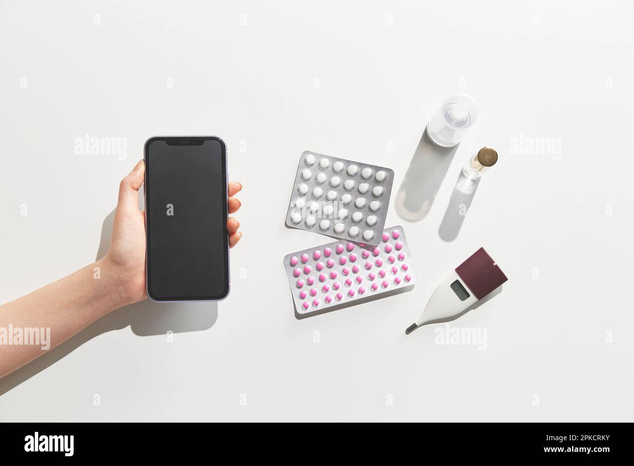 Smartphone, pills and thermometer Stock Photo - Alamy