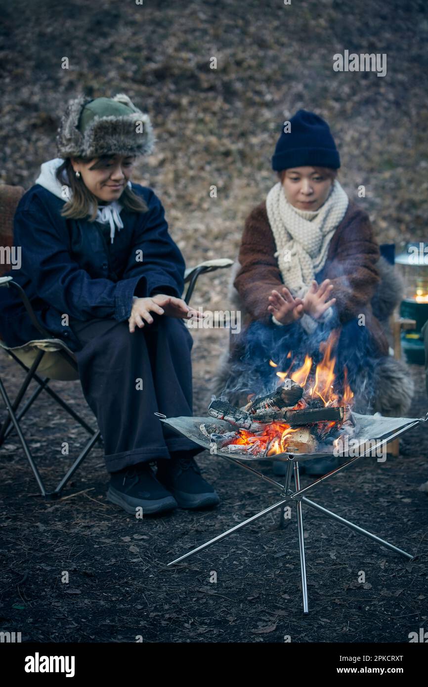 Woman around a campfire Stock Photo - Alamy