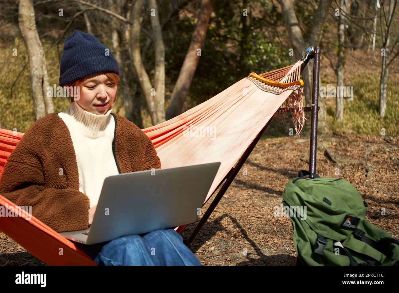 Woman operating a computer in a hammock Stock Photo - Alamy