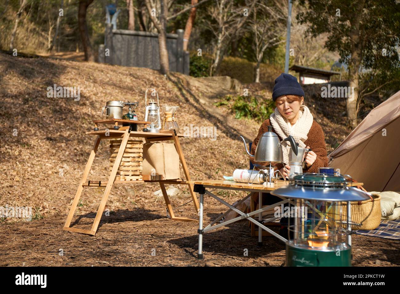 Women camping solo at a winter campsite Stock Photo - Alamy