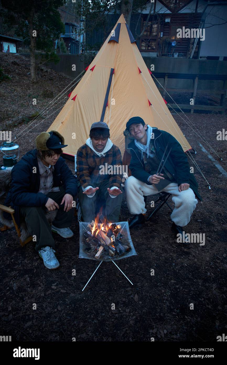 Man surrounding a bonfire Stock Photo - Alamy