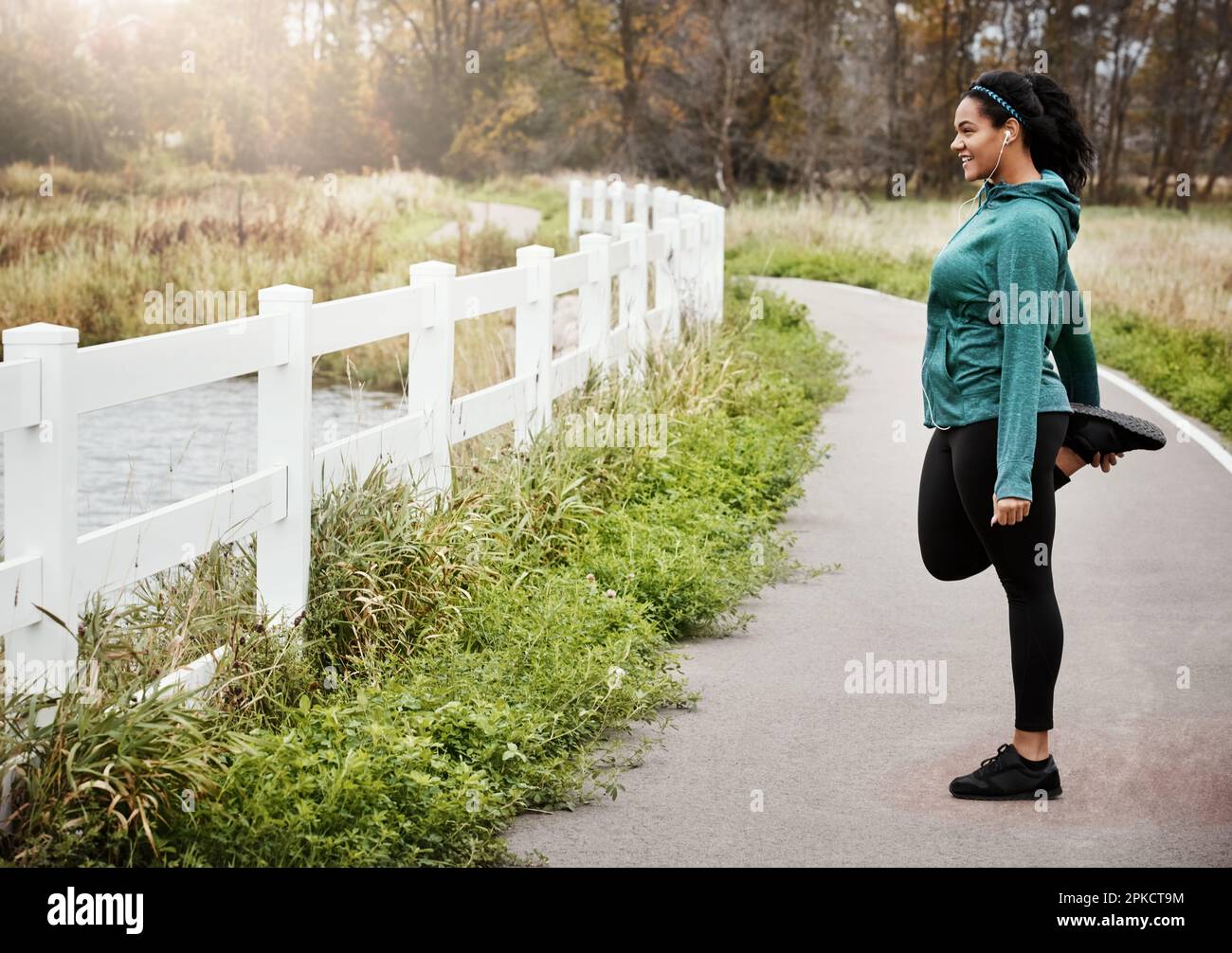 Get those muscles activated. an attractive young woman stretching while ...
