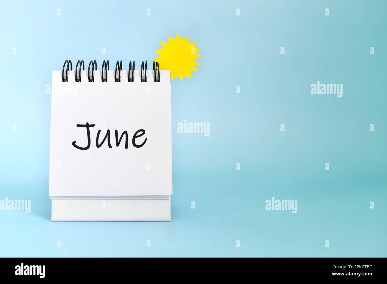 Selective focus of June month desk calendar on blue background with ...