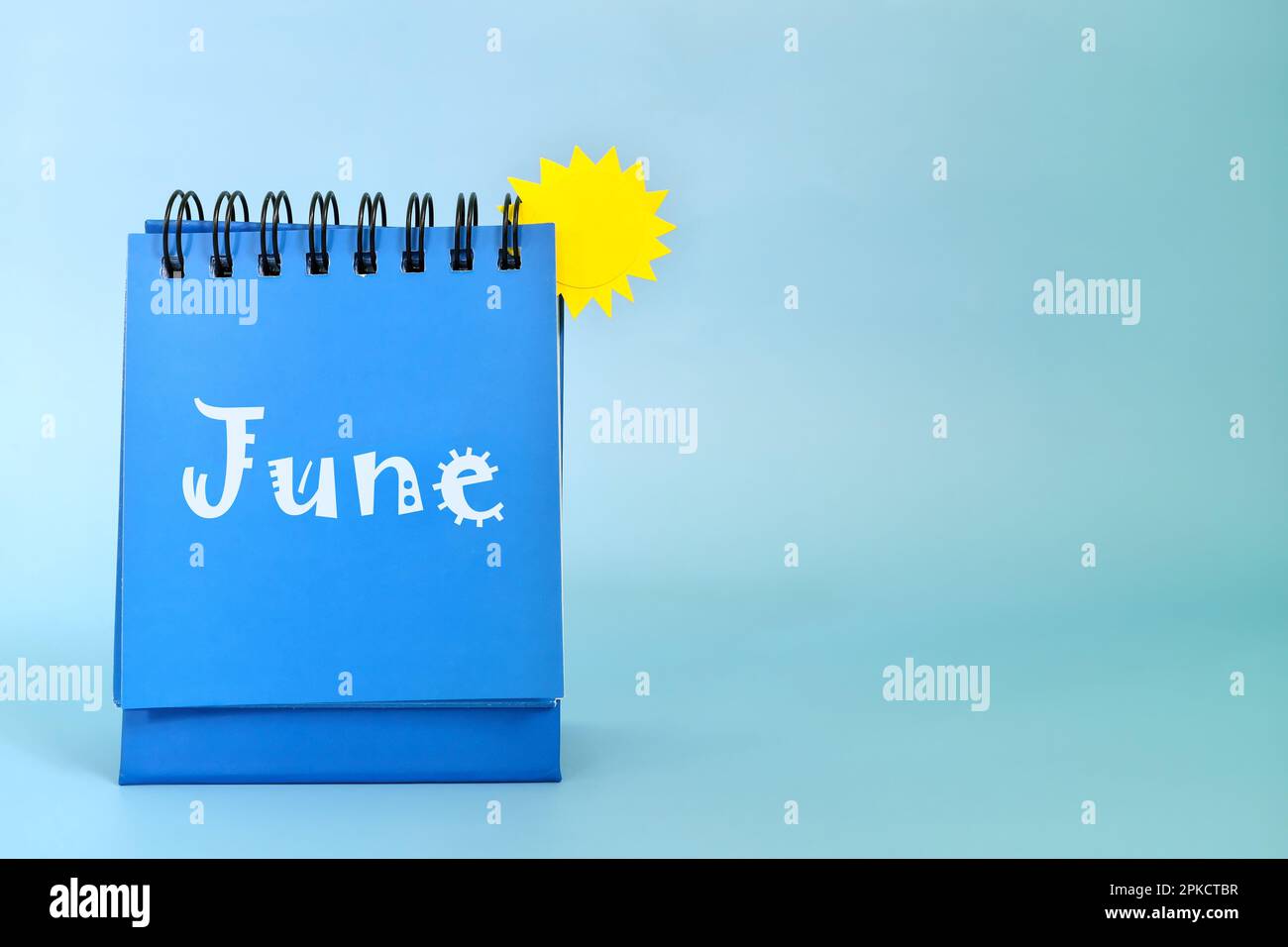 Selective focus of June month desk calendar on blue background with ...