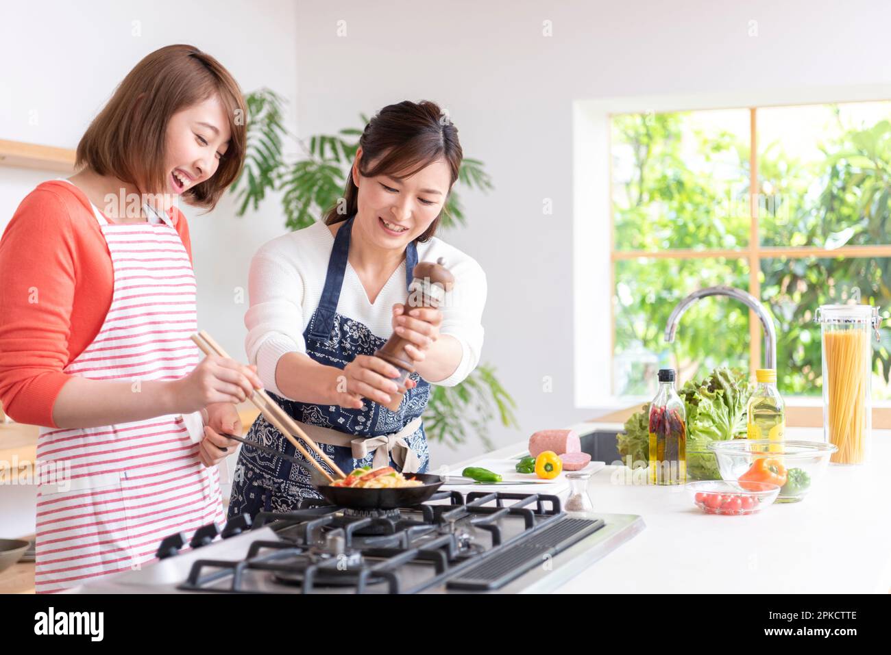 Mother and daughter cooking in the kitchen Stock Photo - Alamy