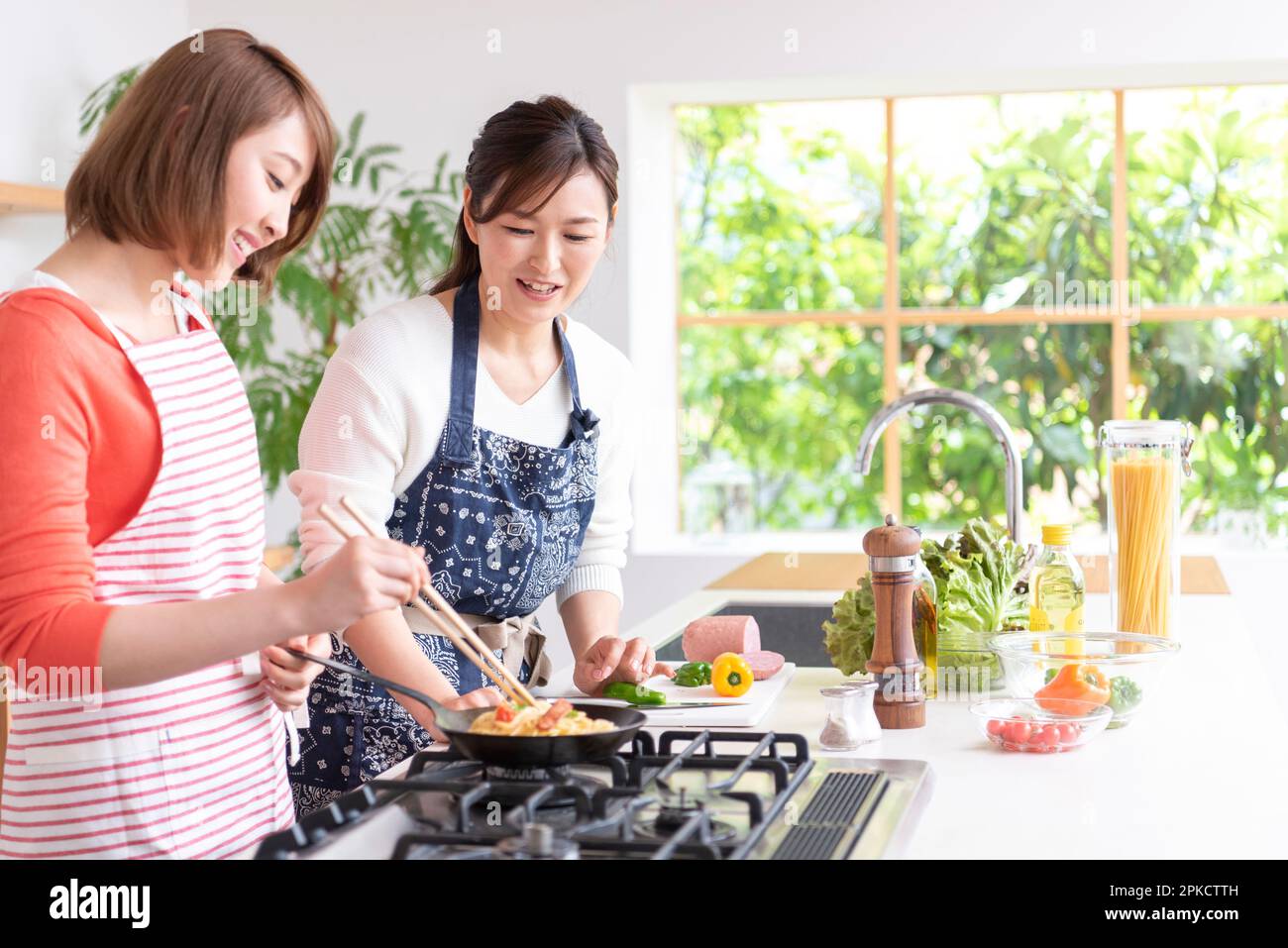 Mother and daughter cooking in the kitchen Stock Photo - Alamy