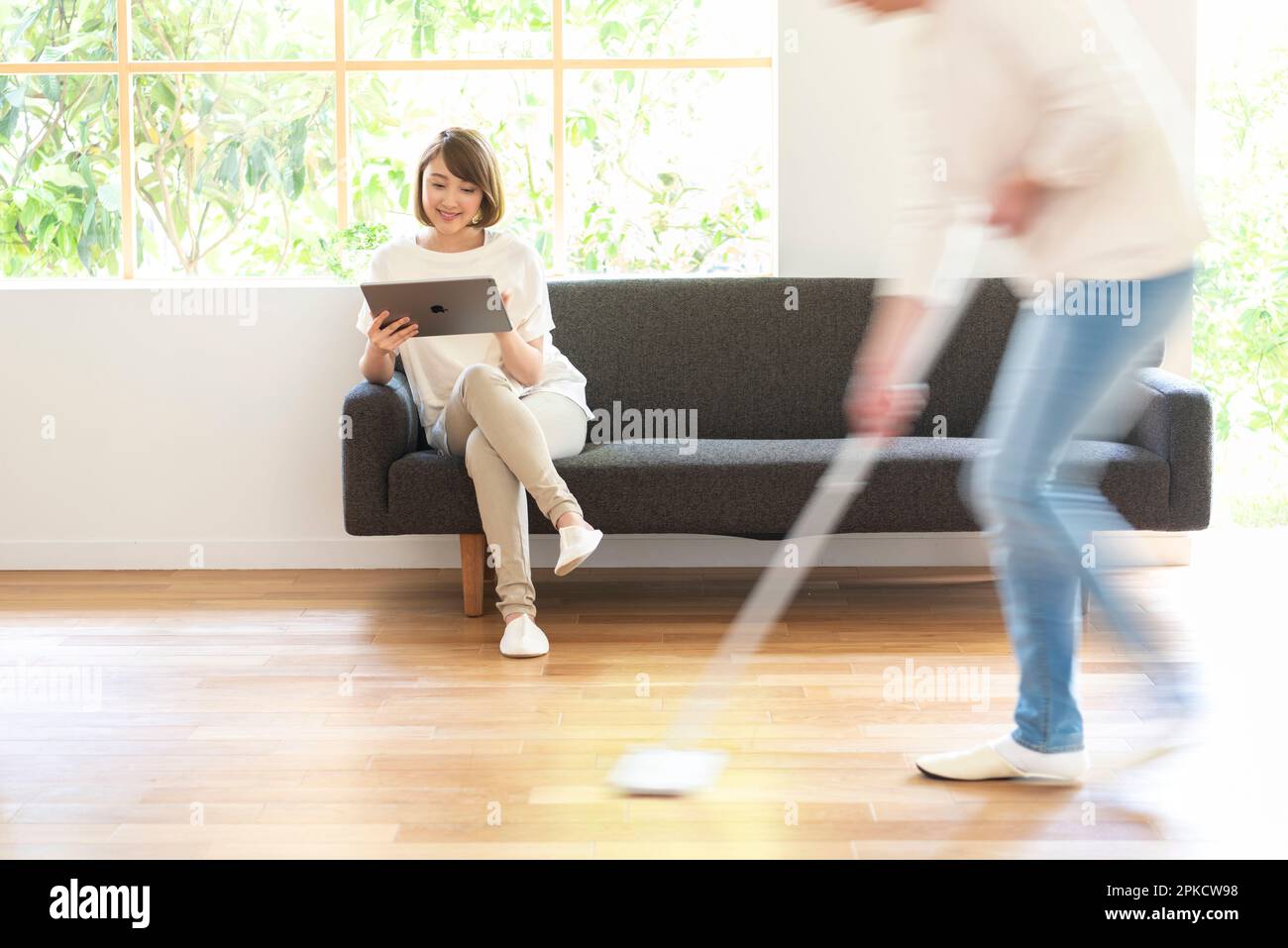 Woman cleaning man watching hi-res stock photography and images - Alamy