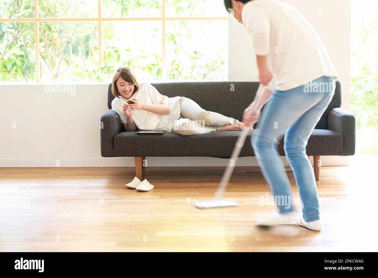 Woman cleaning man watching hi-res stock photography and images - Alamy