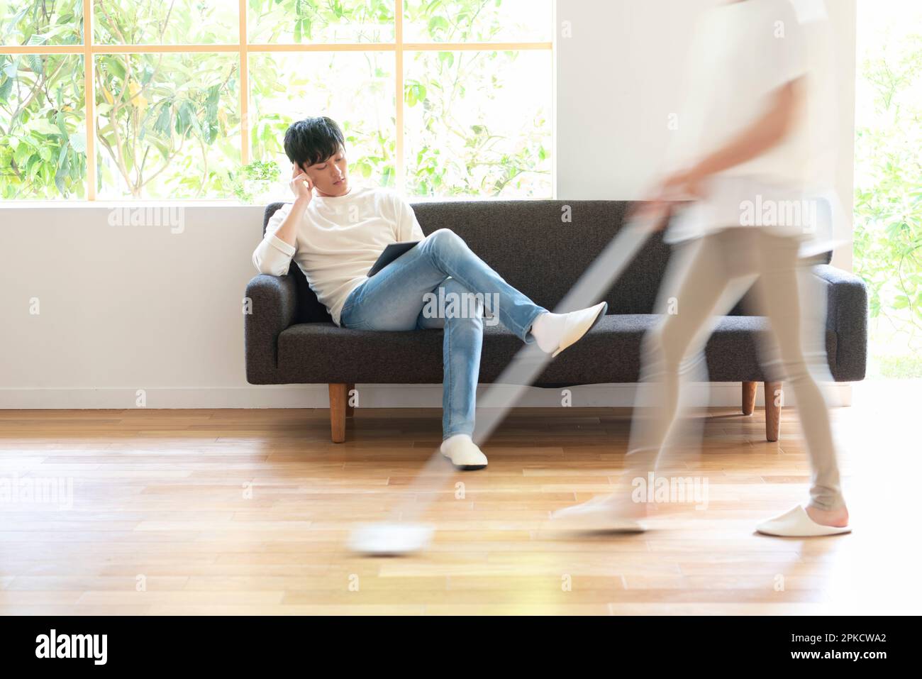 Woman cleaning man watching hi-res stock photography and images - Alamy