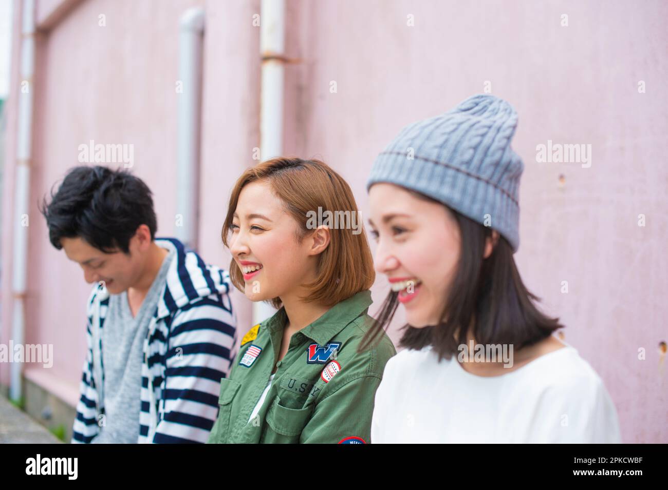 3 men and women in their 20s talking with friends Stock Photo - Alamy