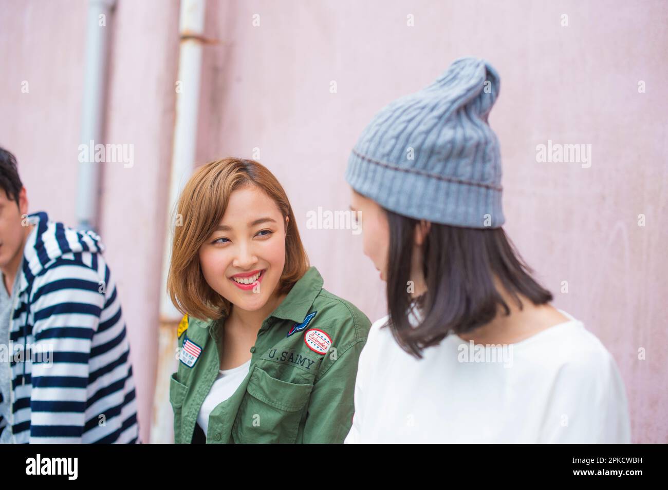 3 men and women in their 20s talking with friends Stock Photo - Alamy