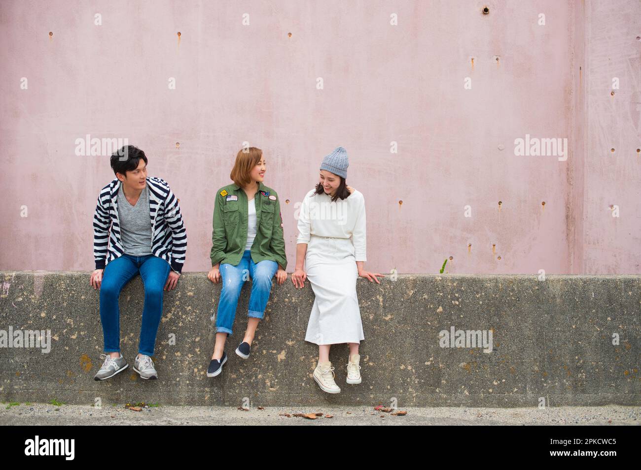 3 men and women in their 20s talking with friends Stock Photo - Alamy