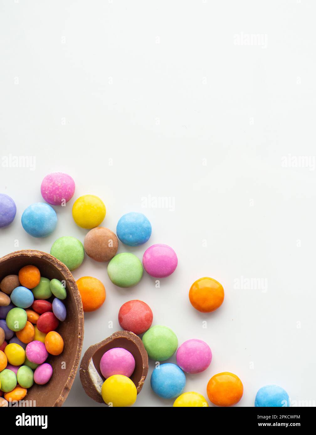 Colorful and chocolate easter eggs with sweet dragee on white ...