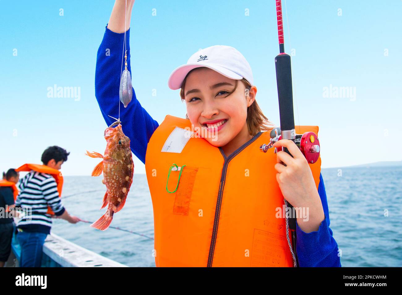 Young asian woman holding fishing hi-res stock photography and images ...