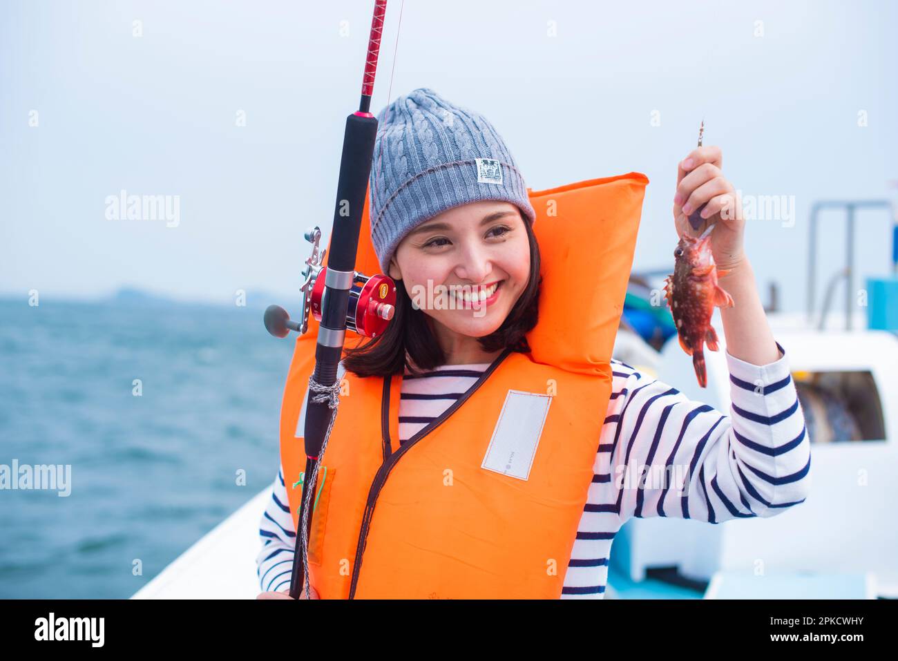 Young asian woman holding fishing hi-res stock photography and images ...