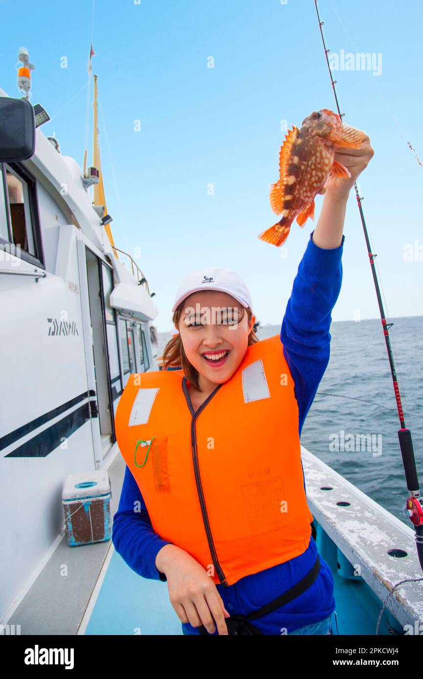 Young asian woman holding fishing hi-res stock photography and images ...