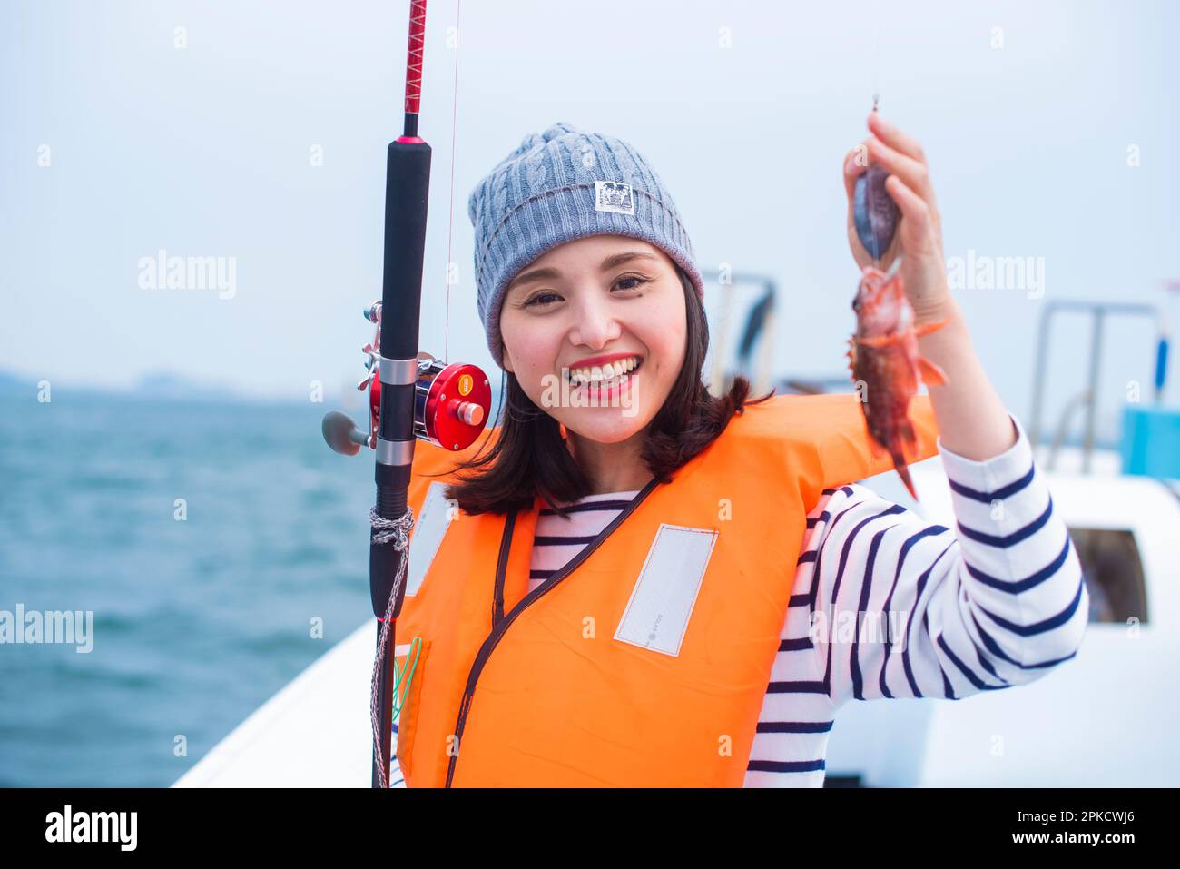 Young asian woman holding fishing hi-res stock photography and images ...