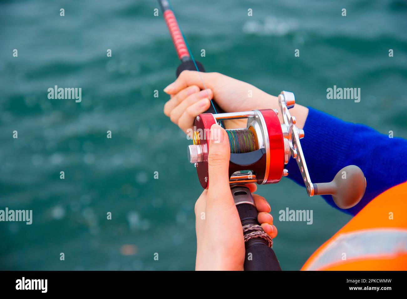A hand holding a fishing rod Stock Photo - Alamy