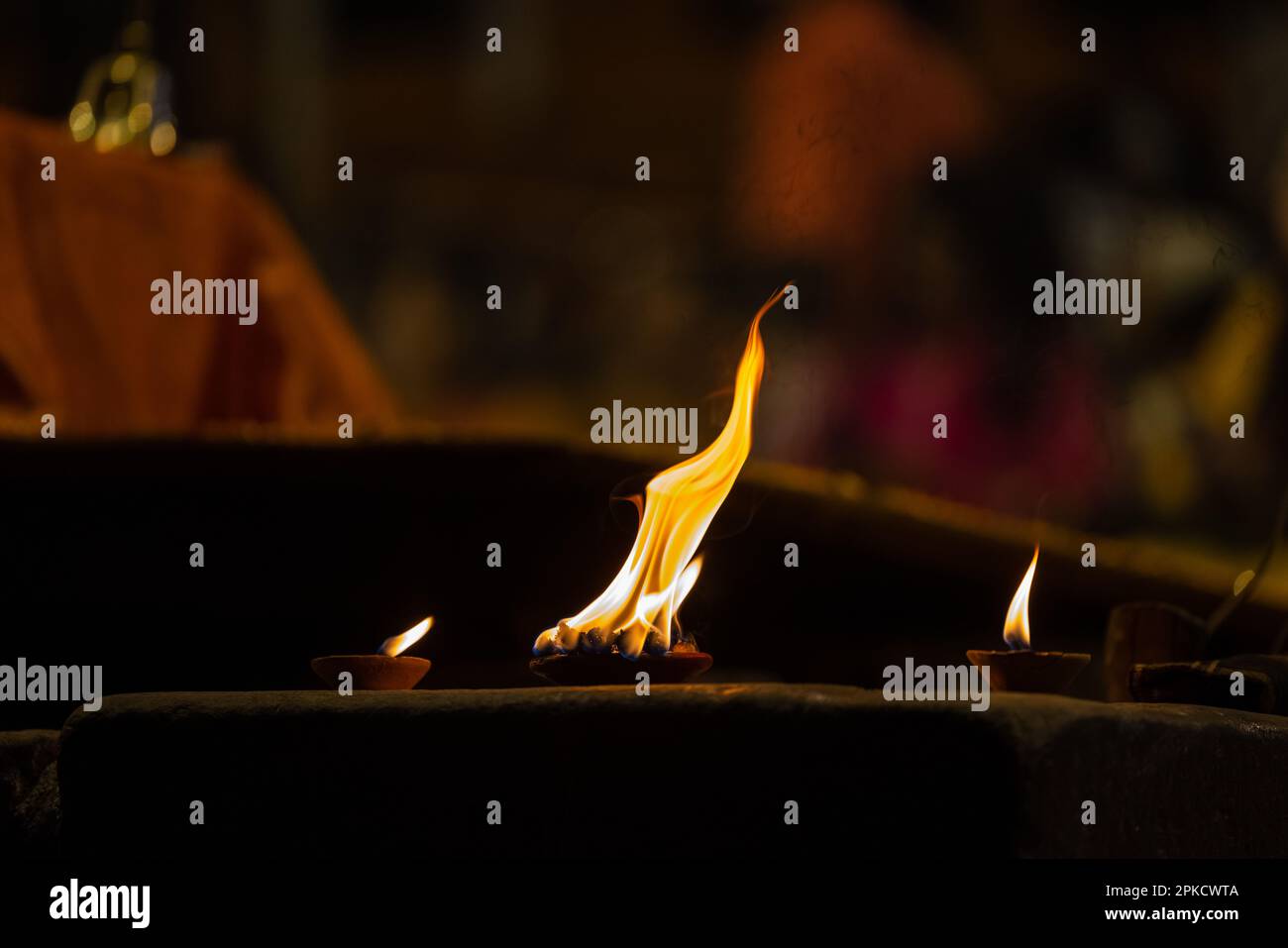 Fire flame at night with dark background during the ganga aarti rituals ...