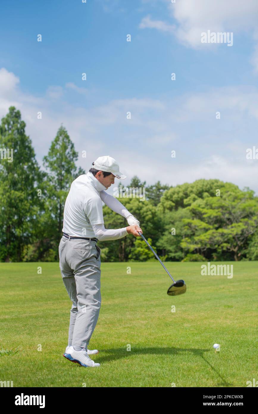 A middle-aged man playing golf Stock Photo - Alamy