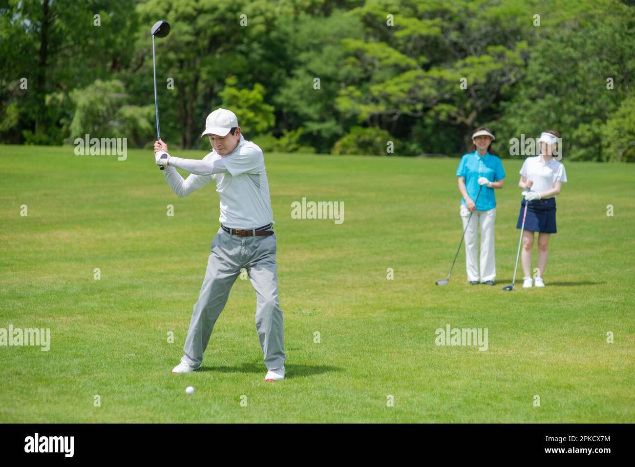 Family of three playing golf Stock Photo - Alamy